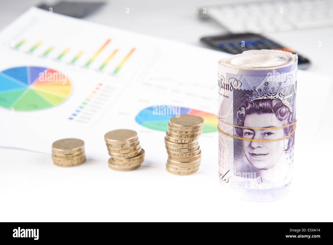 British pound coins and notes with financial chart Stock Photo - Alamy