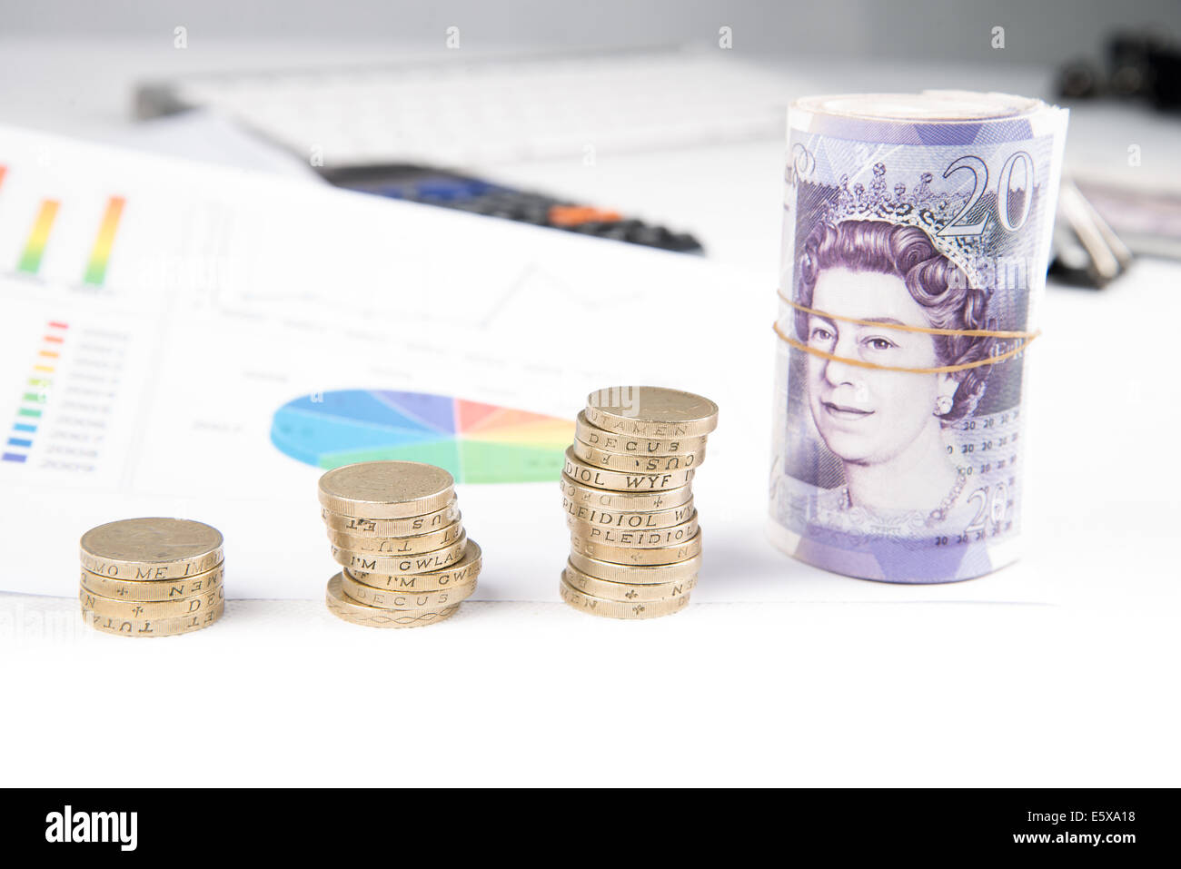 British pound coins and notes with financial chart Stock Photo - Alamy