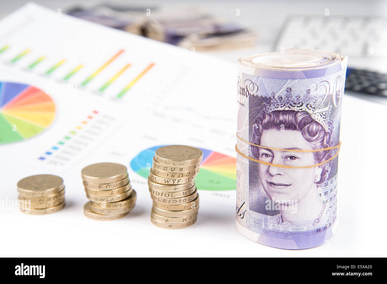British pound coins and notes with financial chart Stock Photo - Alamy