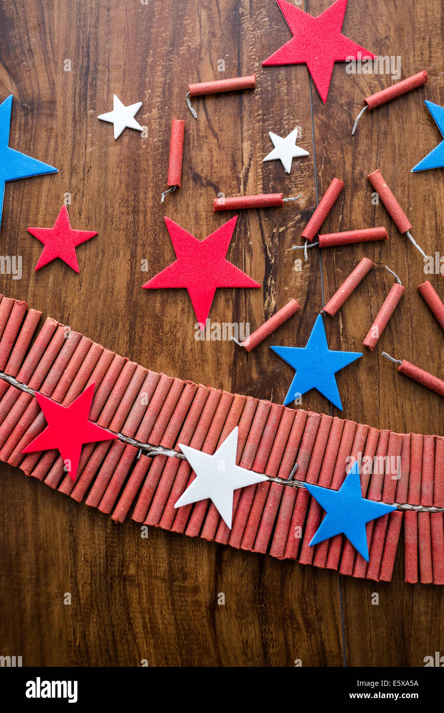 Roll of firecrackers with red, white and blue stars on wood table Stock ...