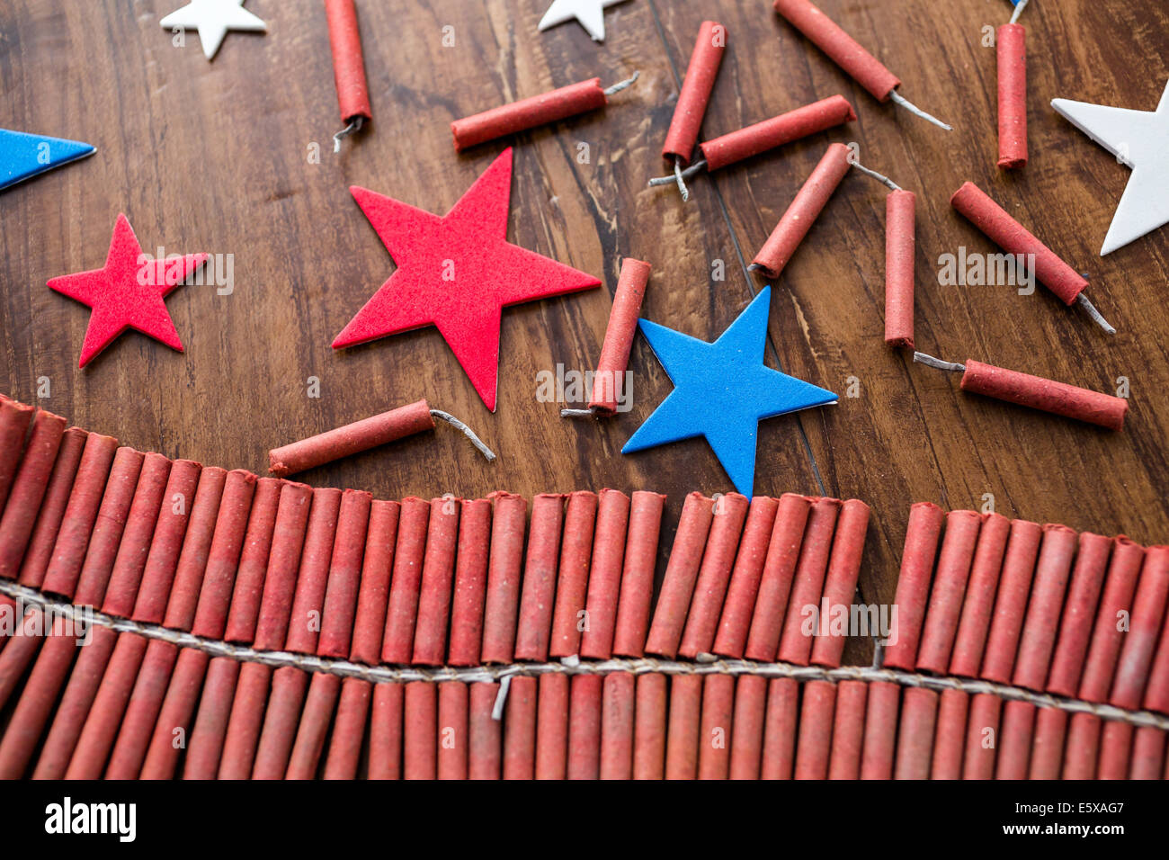 Roll of firecrackers with red, white and blue stars on wood table Stock ...