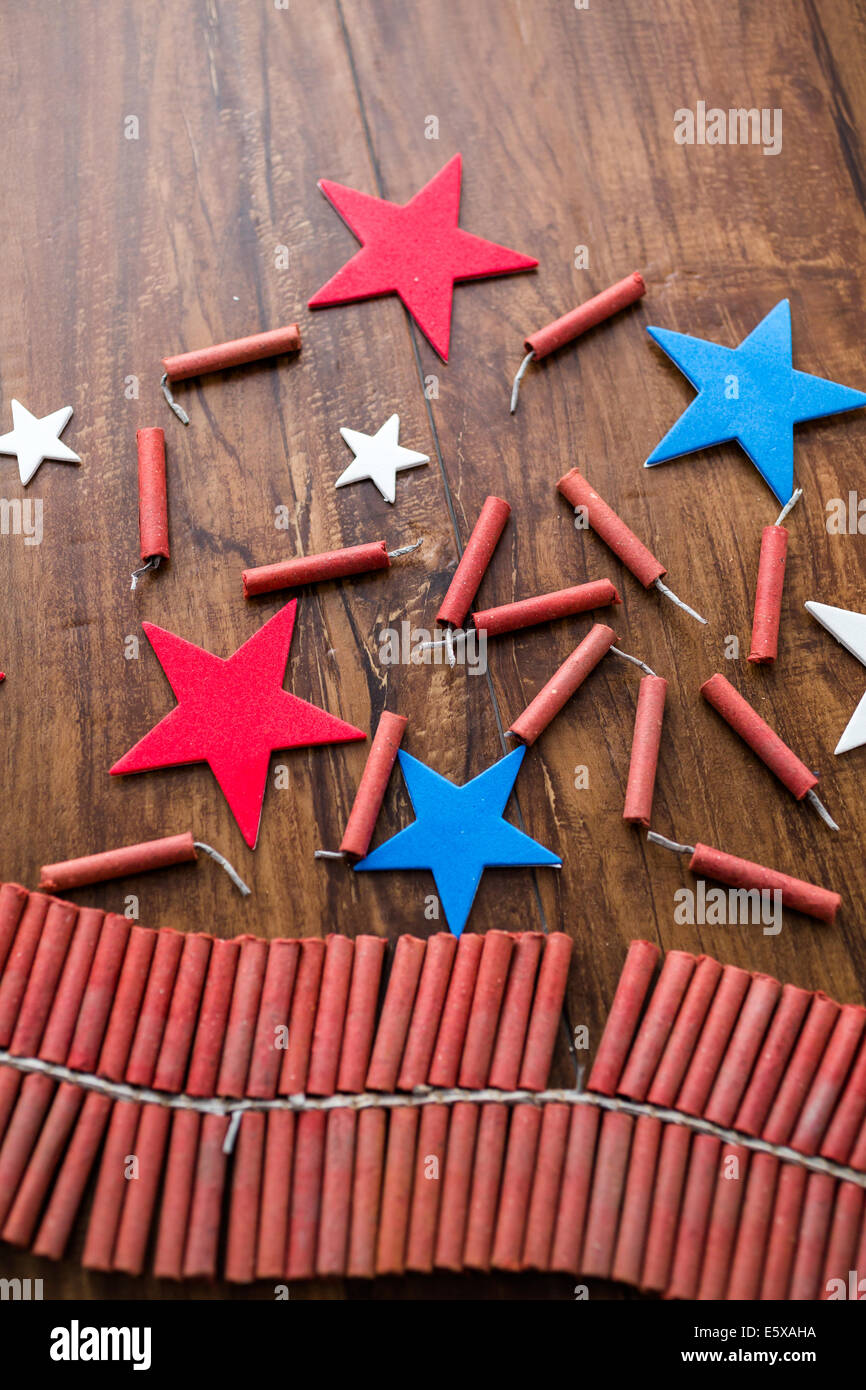 Roll of firecrackers with red, white and blue stars on wood table Stock ...