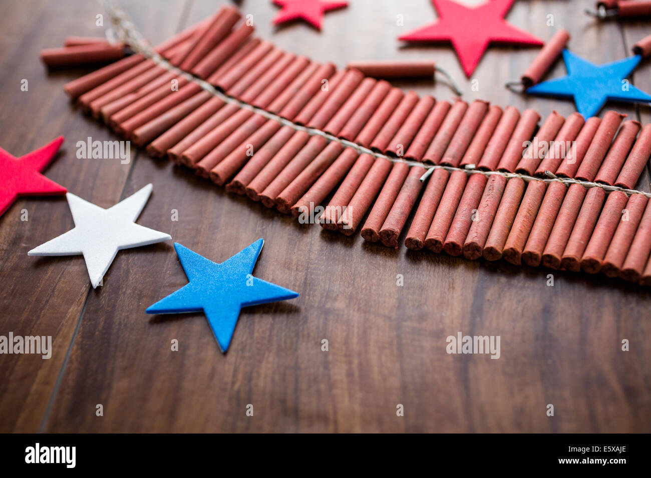 Roll of firecrackers with red, white and blue stars on wood table Stock ...