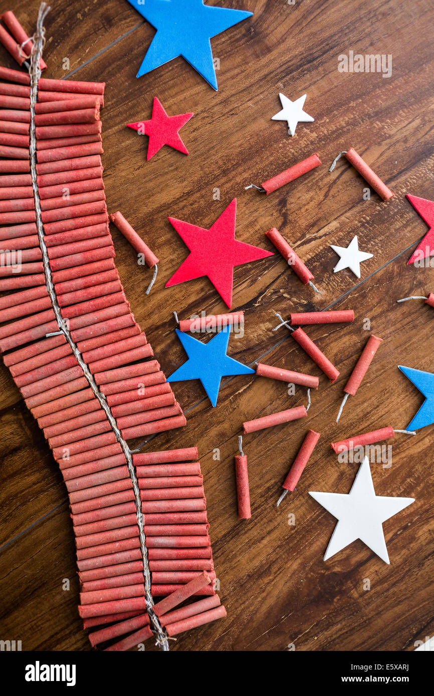 Roll of firecrackers with red, white and blue stars on wood table Stock ...
