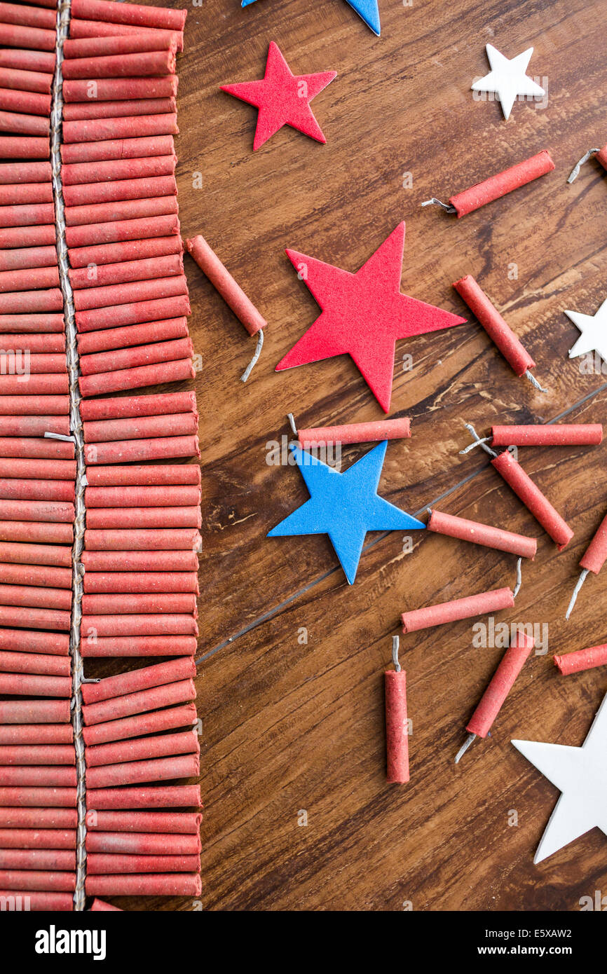 Roll of firecrackers with red, white and blue stars on wood table Stock ...