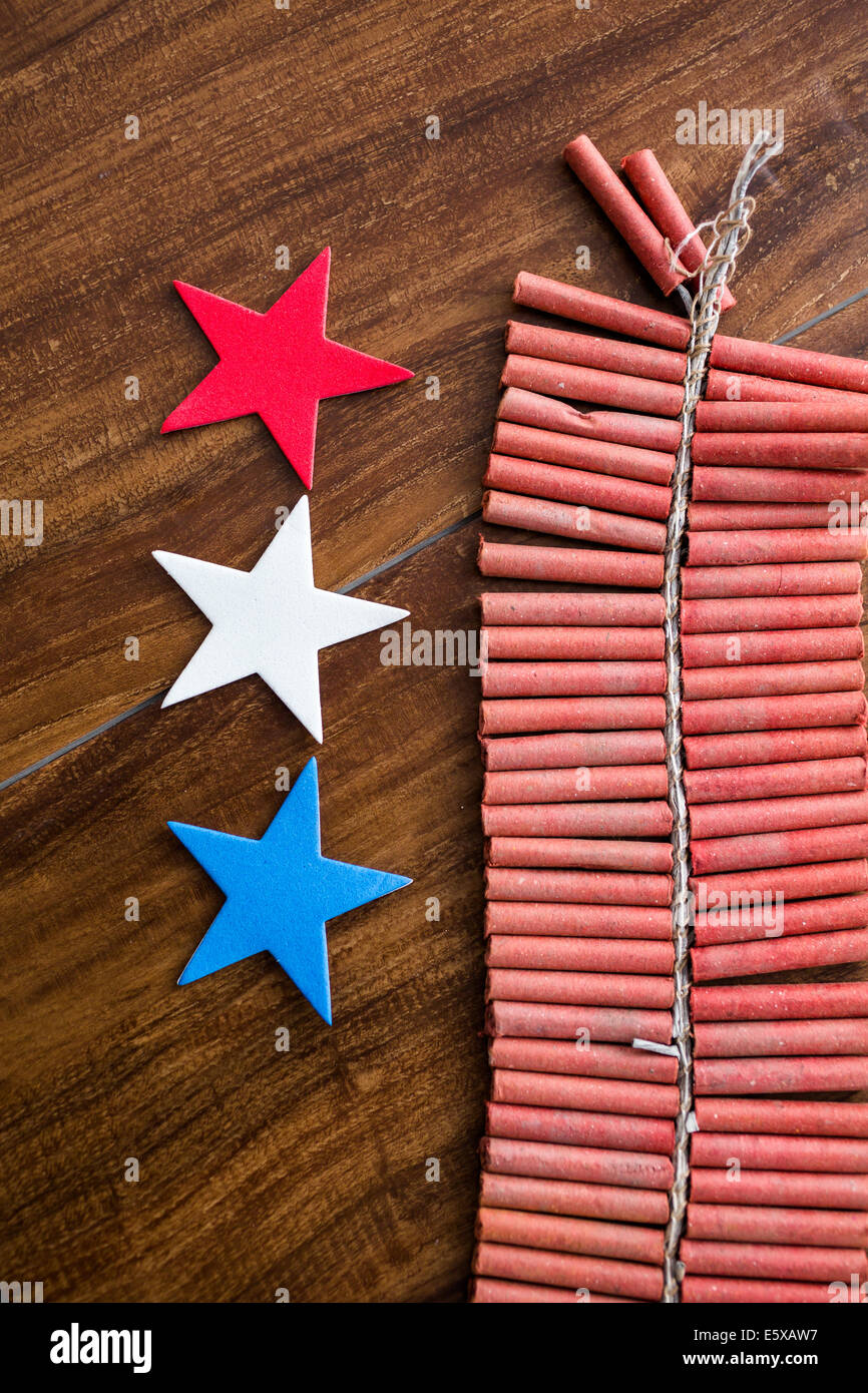 Roll of firecrackers with red, white and blue stars on wood table Stock ...