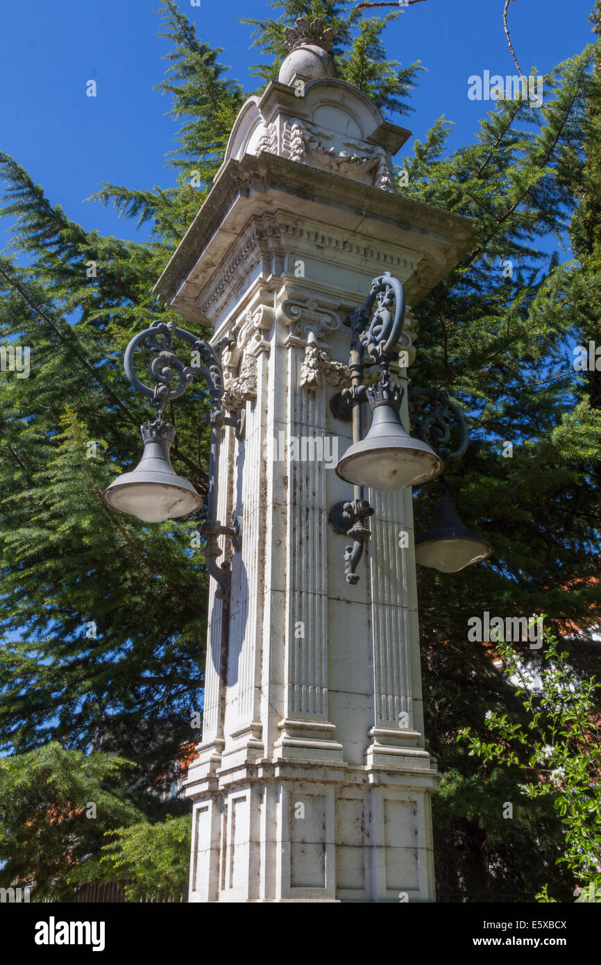 Streetlights on ancient decorated stone column Stock Photo - Alamy