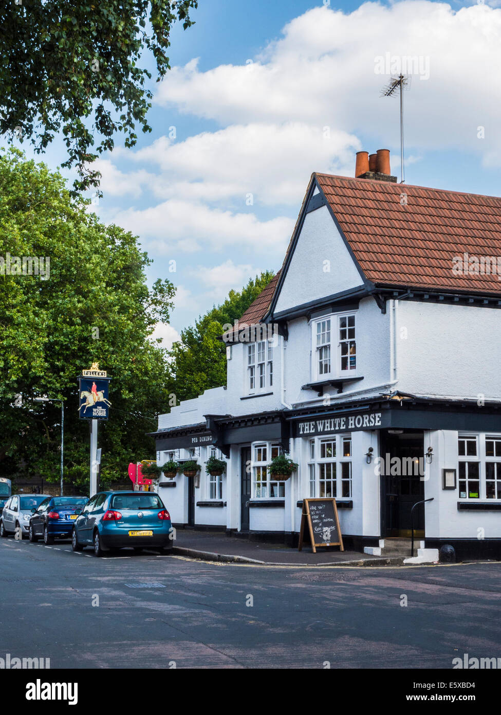 The White Horse pub - exterior of traditional English pub with chairs ...