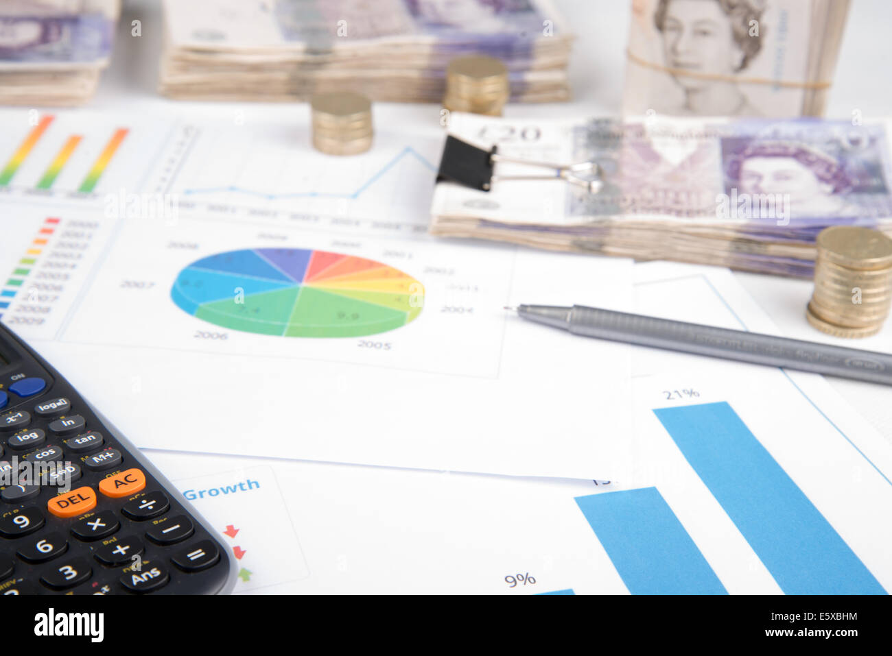 British pound coins and notes with financial chart Stock Photo - Alamy