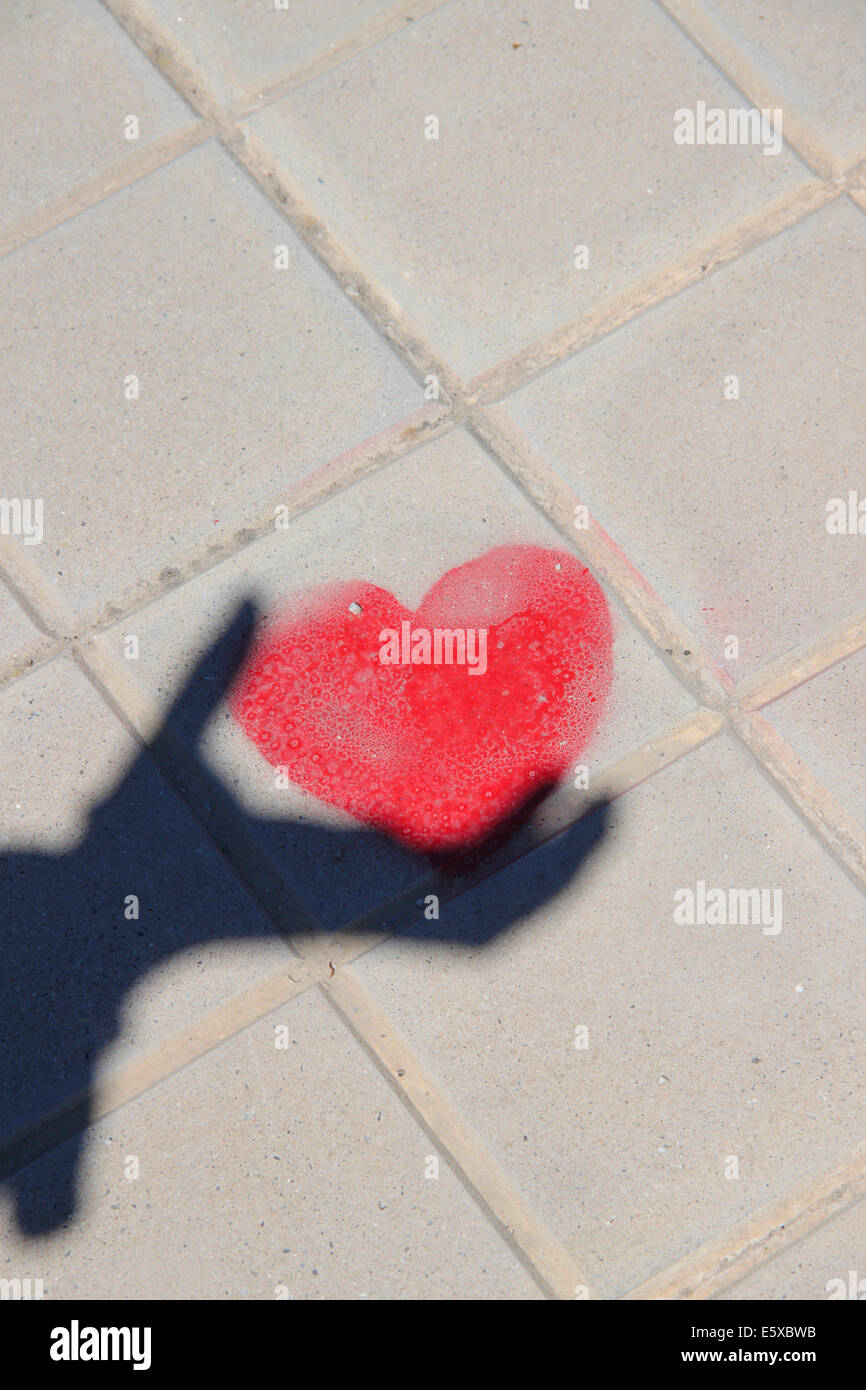 shadow of hand with red heart Stock Photo - Alamy