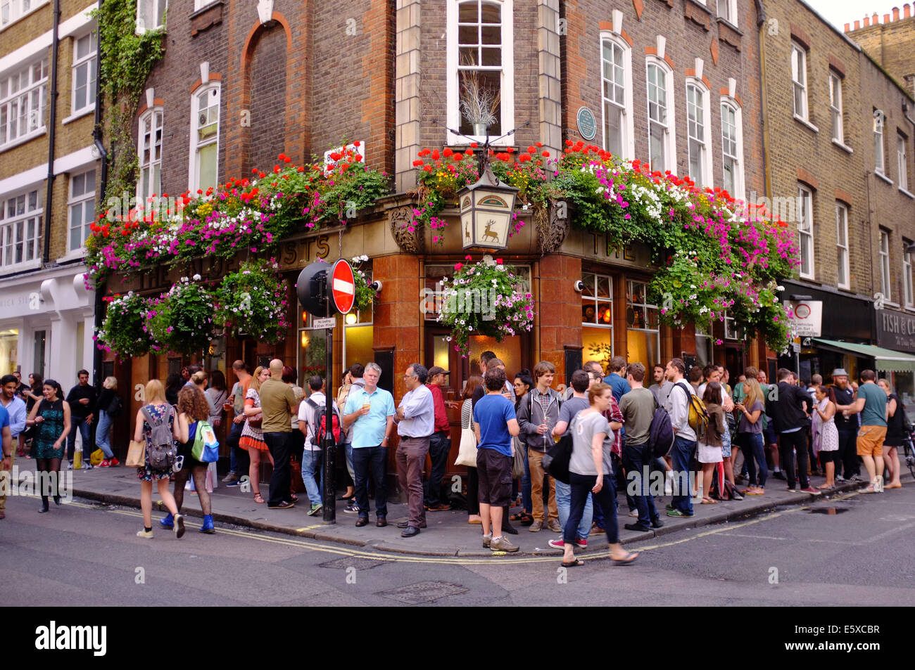 Crowds of drinkers standing outside The Blue Ghost pub in London Stock Photo - Alamy