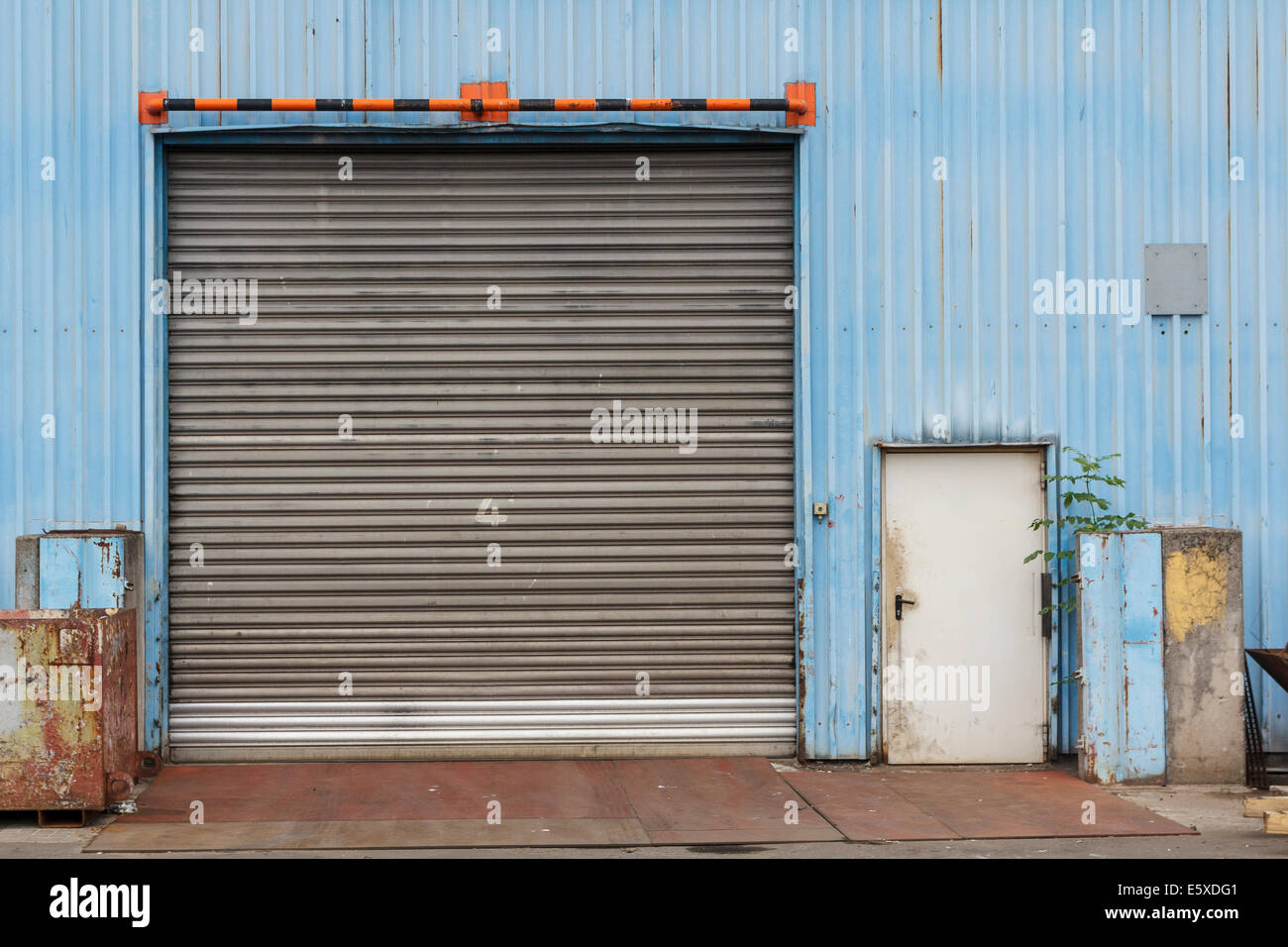 Closed gate in blue metal shed at industrial facility Stock Photo - Alamy