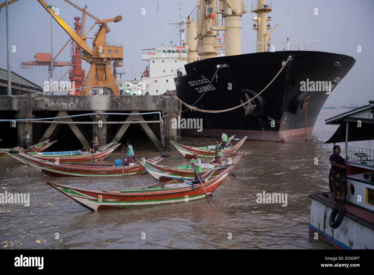 Ferrymen working the Yangon-Dala crossing wait to dock and pick up ...