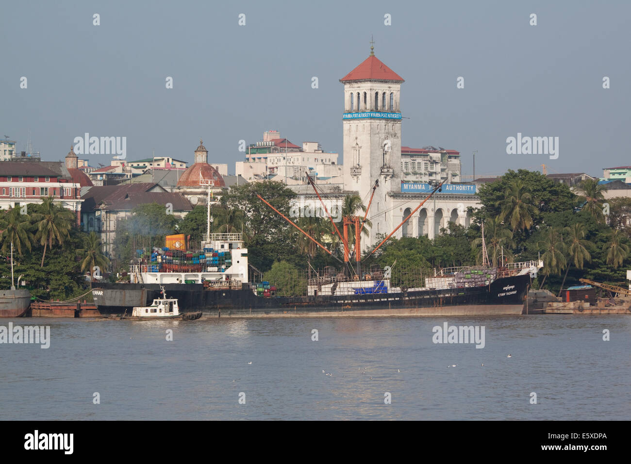 A ship and the Myanmar Port Authority building by the Yangon river in ...