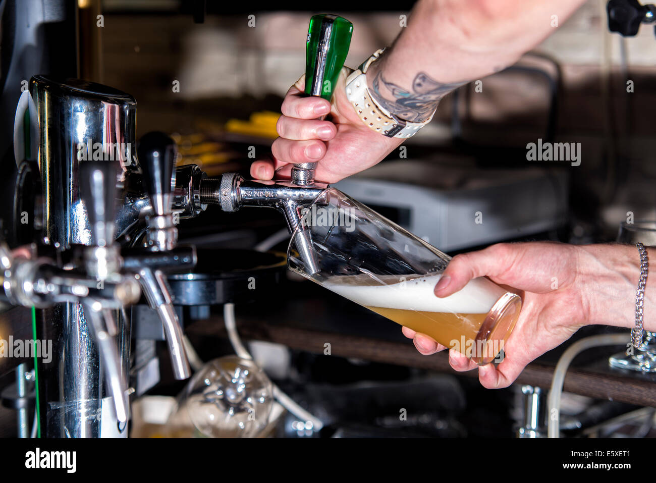 bartender pouring beer into a glass from the tap Stock Photo - Alamy
