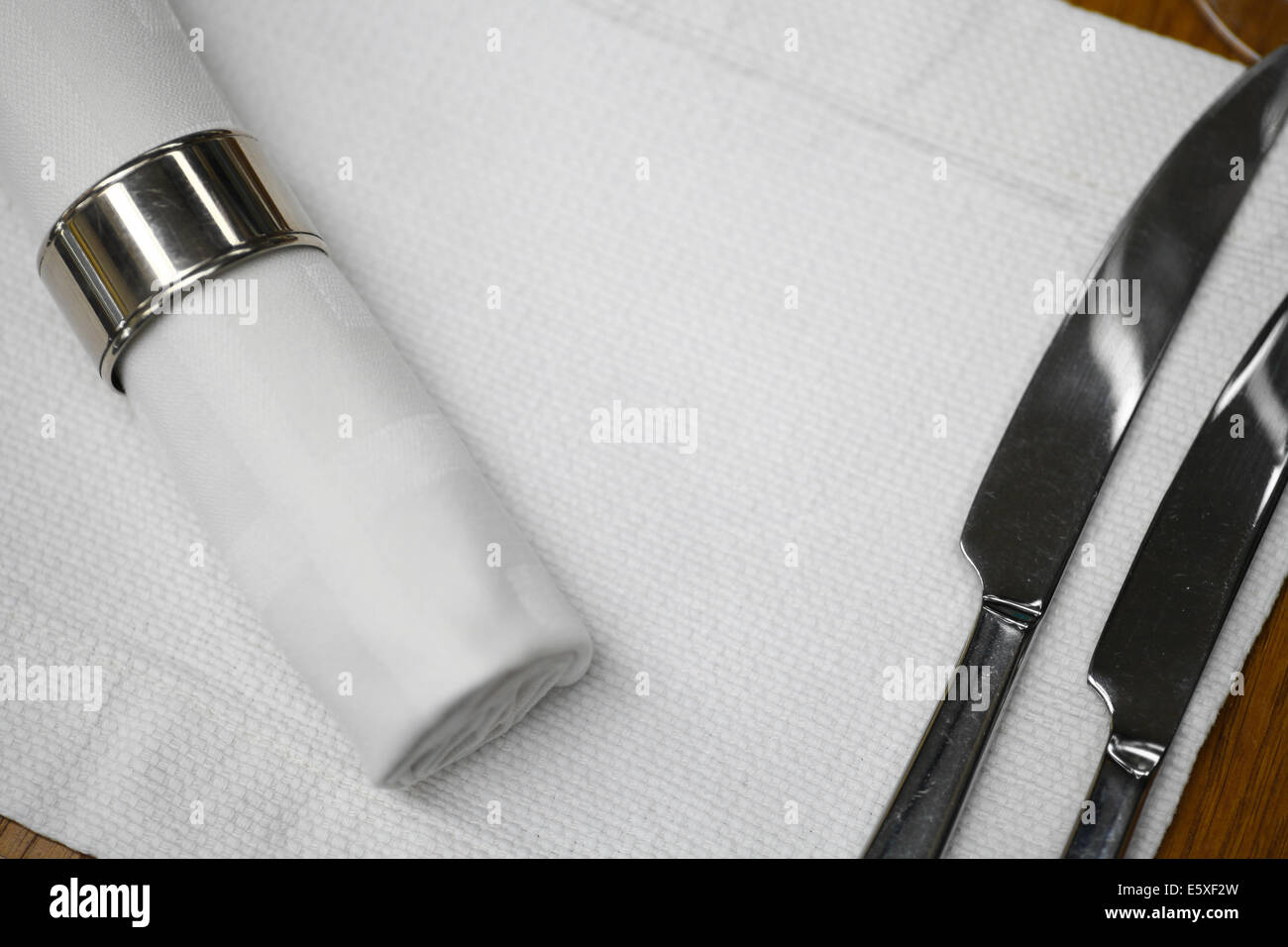 Two knives on a dinner table in a restaurant Stock Photo - Alamy