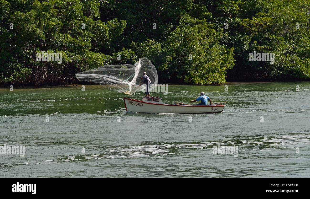 Traditional way of casting a fishing net from a boat, in Valadero Stock ...