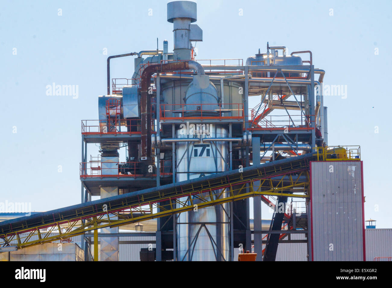 metal deposits and a small factory chimneys Stock Photo - Alamy