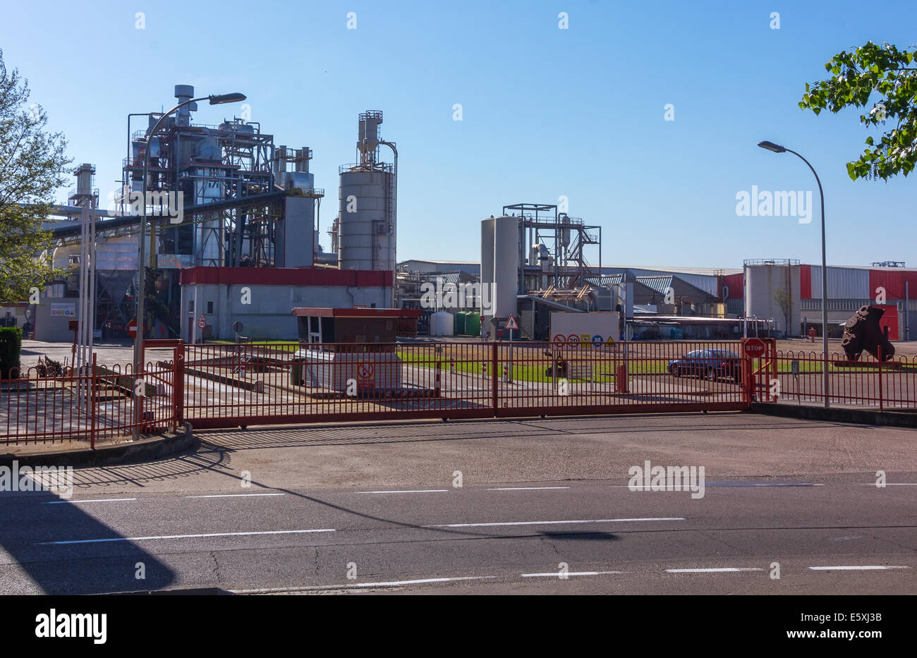 metal deposits and a small factory chimneys Stock Photo - Alamy