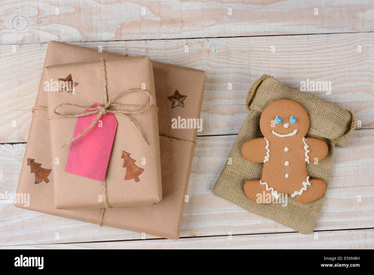 High angle shot of two Christmas presents and a gingerbread man on a ...