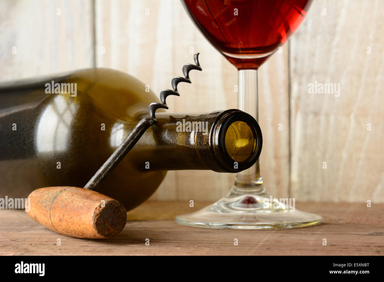 Wine still life with a bottle on its side and the bottom of a glass of ...