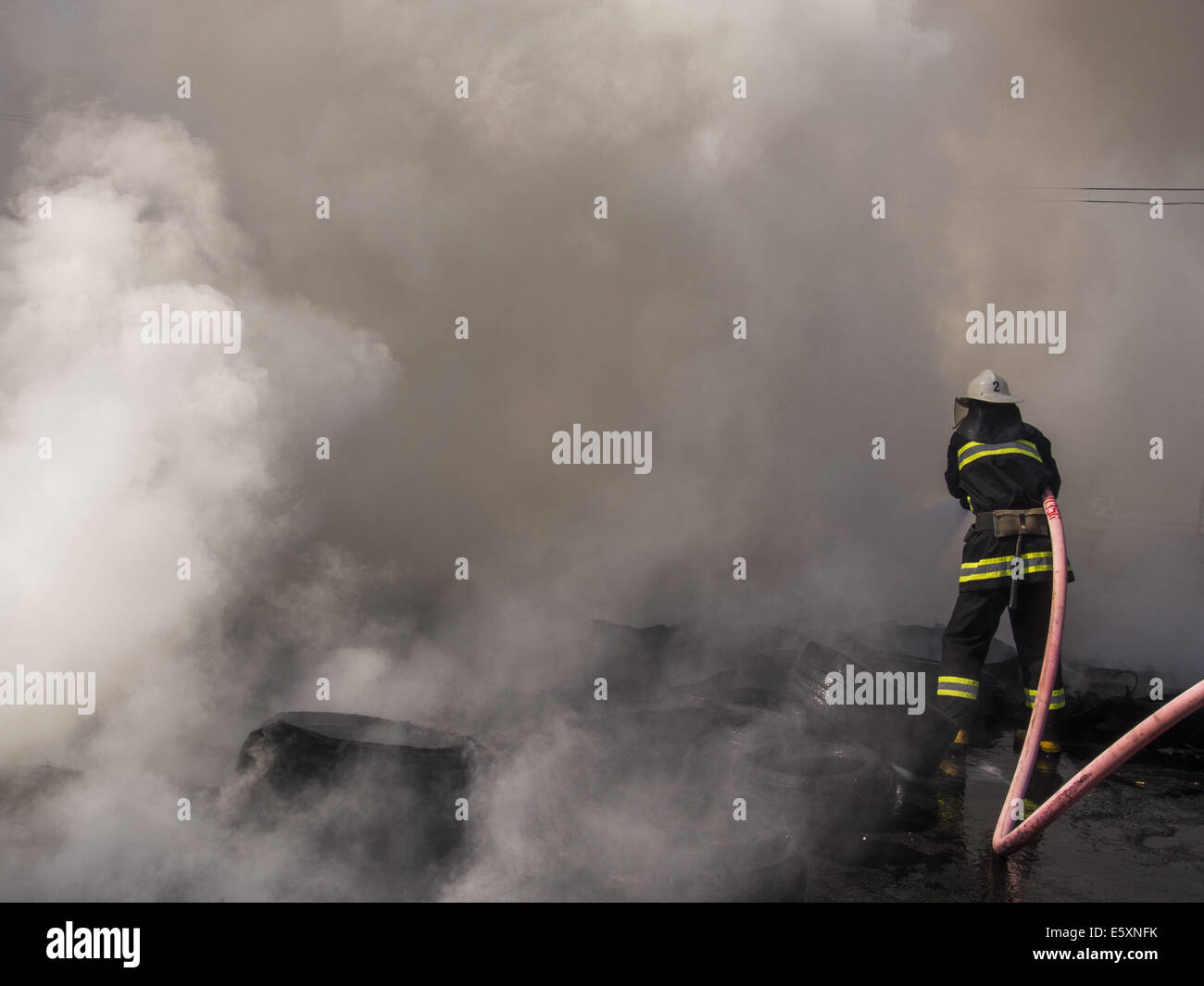 Kiev, Ukrain. 7yh Aug, 2014. Firefighters extinguish a barricade of ...