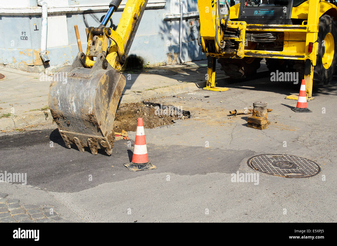 Public street day maintenance works, excavator work Stock Photo - Alamy