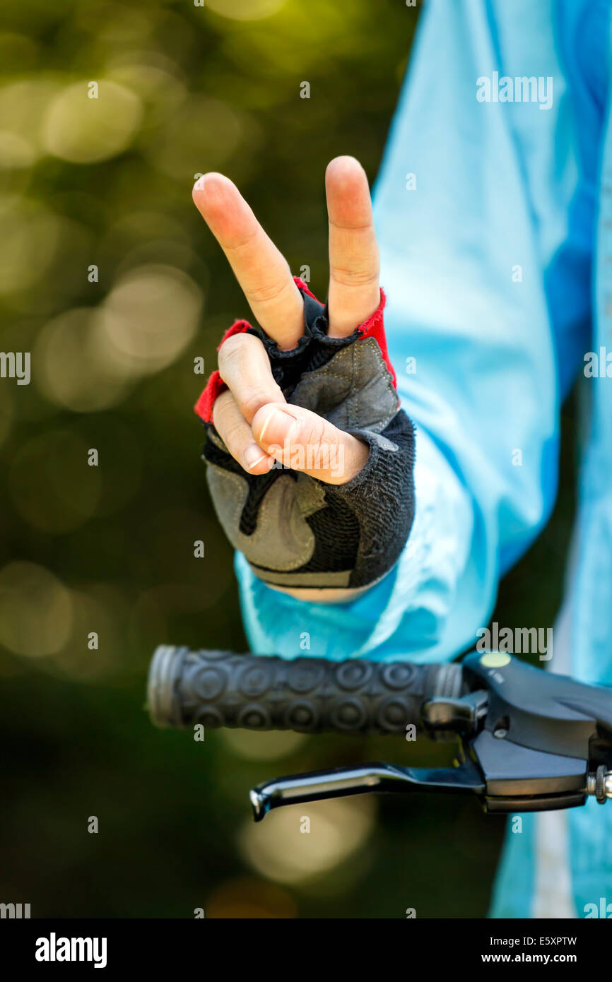 Biker showing victory sign - cycling concept image Stock Photo - Alamy