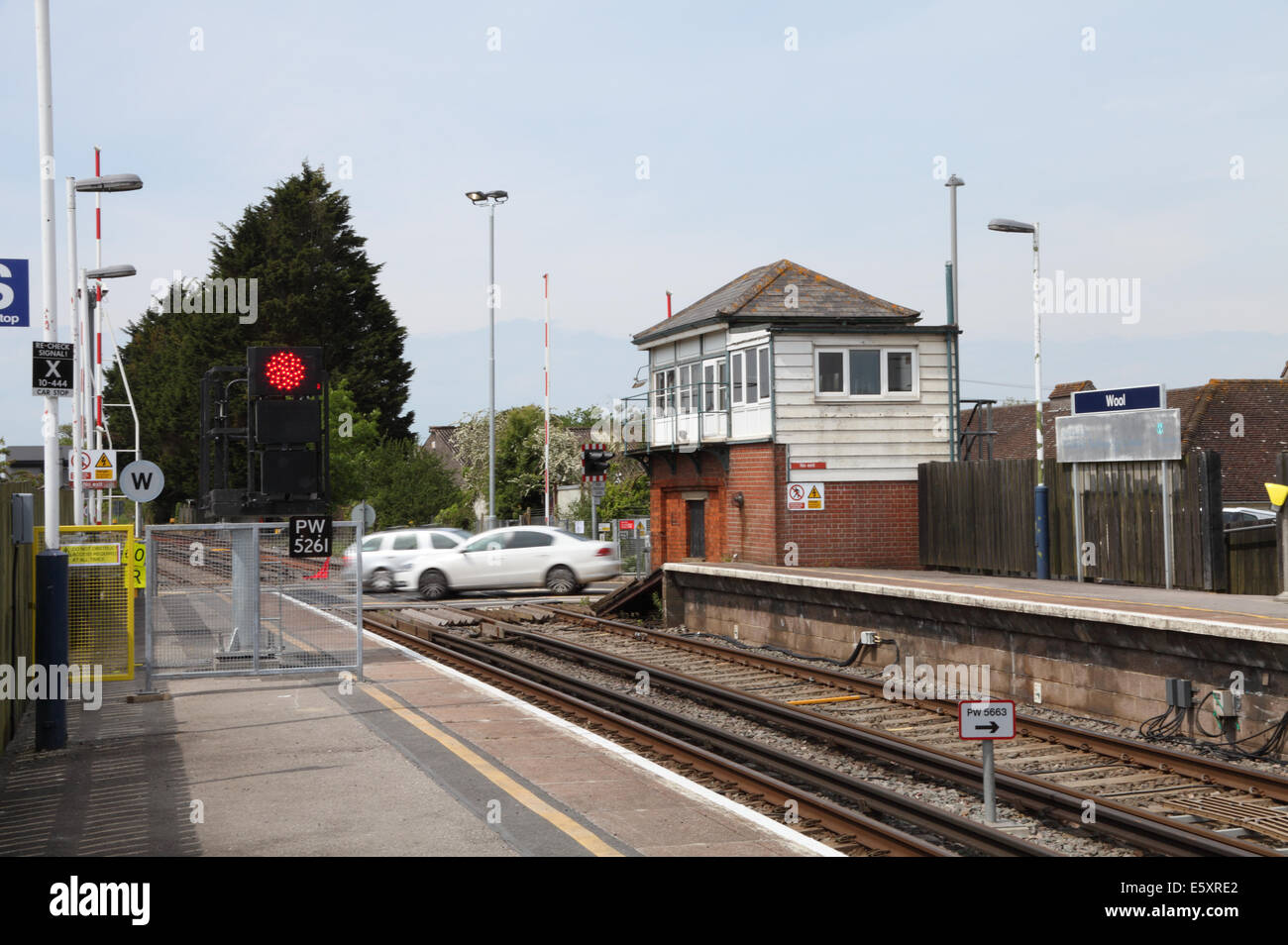 Cars cross the tracks at Wool station level crossing, East Dorset ...