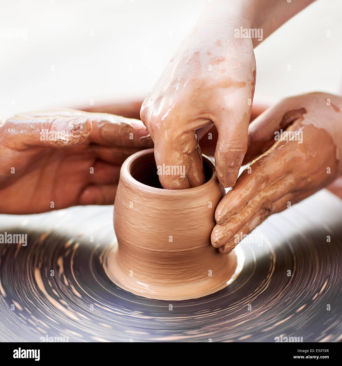 Female Potter creating a bowl on a Potters wheel, the master potter ...