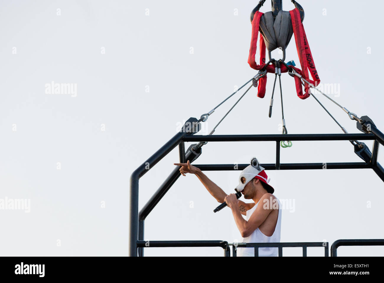 Cologne, Germany. 07th Aug, 2014. The rapper Cro is hoisted up over the ...
