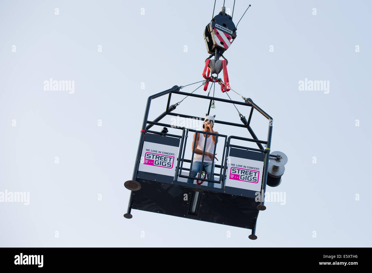 Cologne, Germany. 07th Aug, 2014. The rapper Cro is hoisted up over the ...