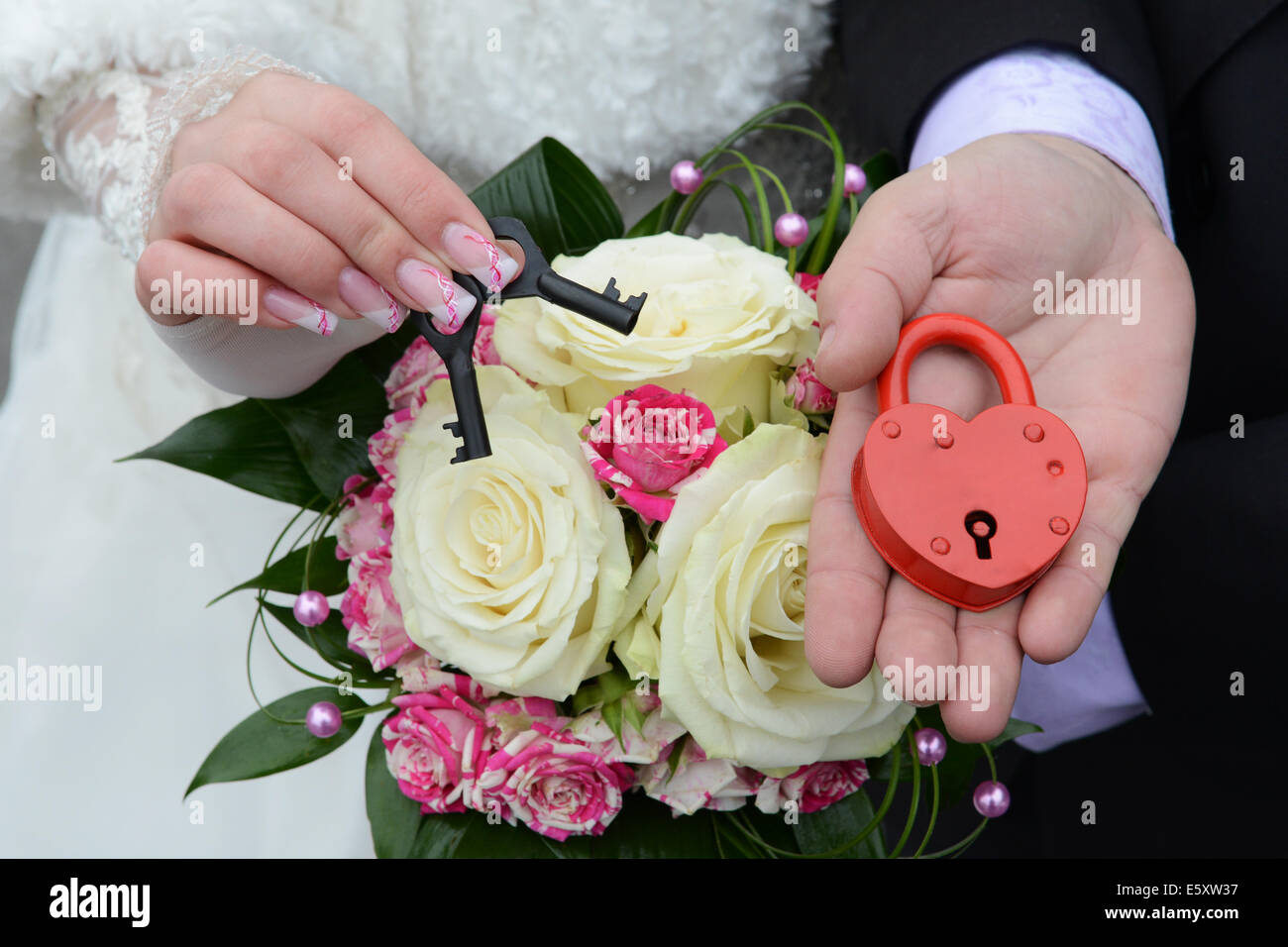 couple's hands holding wedding lock and keys Stock Photo - Alamy