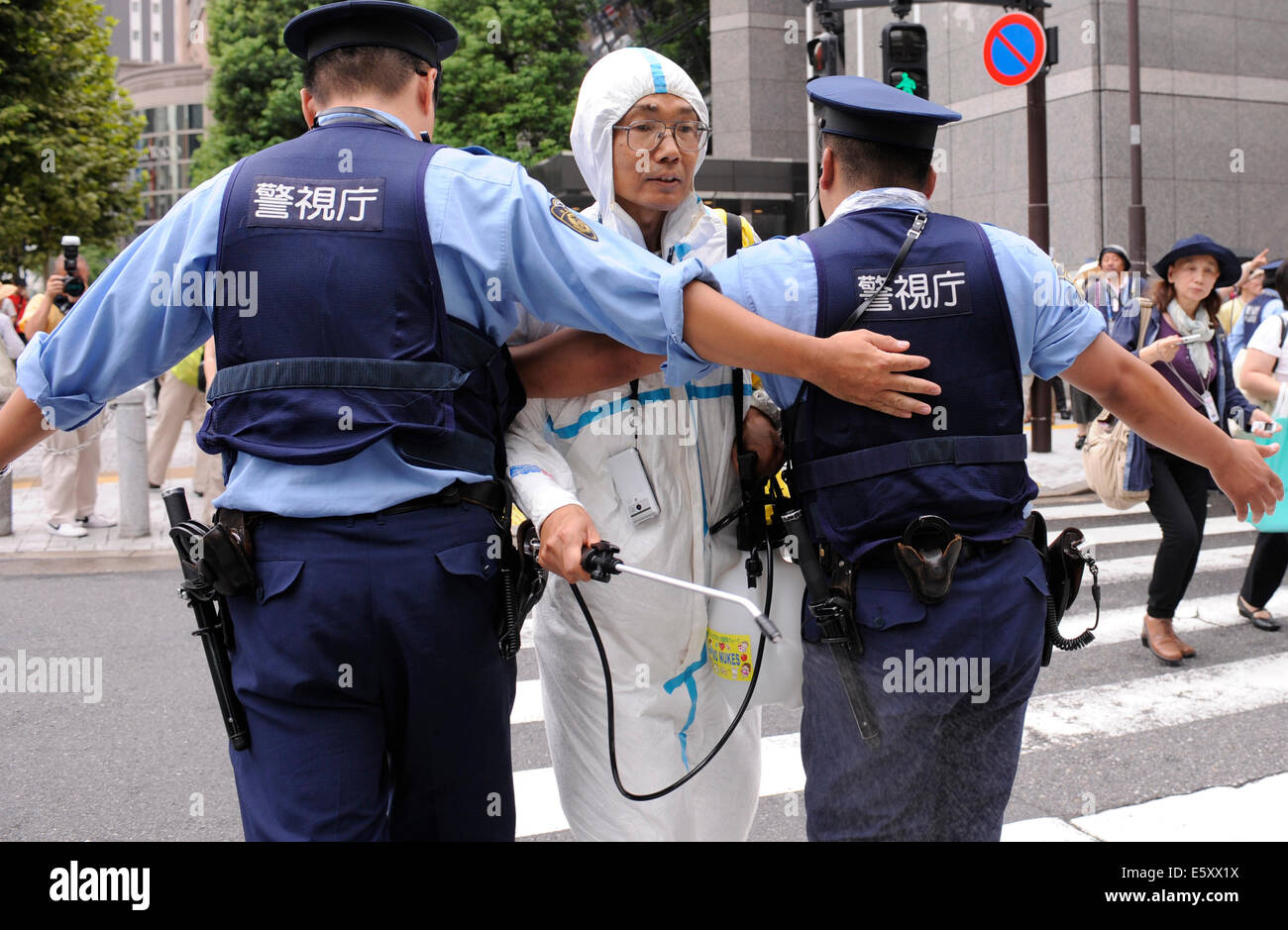 Tokyo, Japan. 8th Aug, 2014. Police officers block a protester during ...