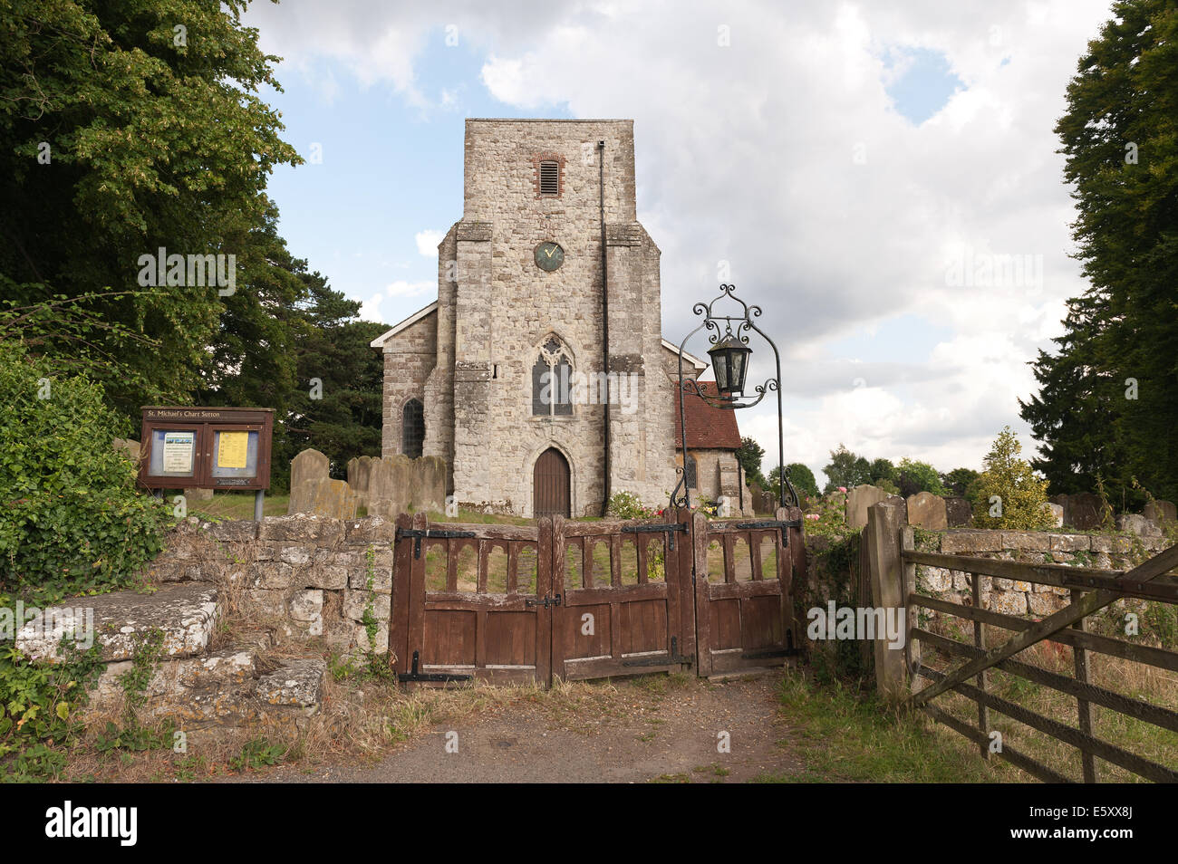 Chart Sutton Norman Church on a changeable weather day in mid summer a ...