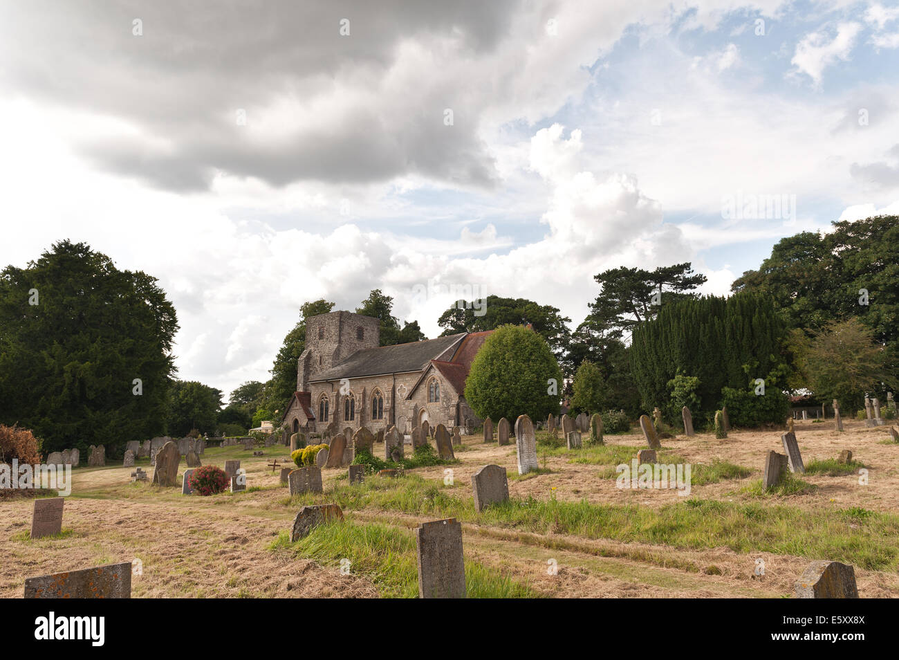 Chart Sutton Norman Church on a changeable weather day in mid summer a ...