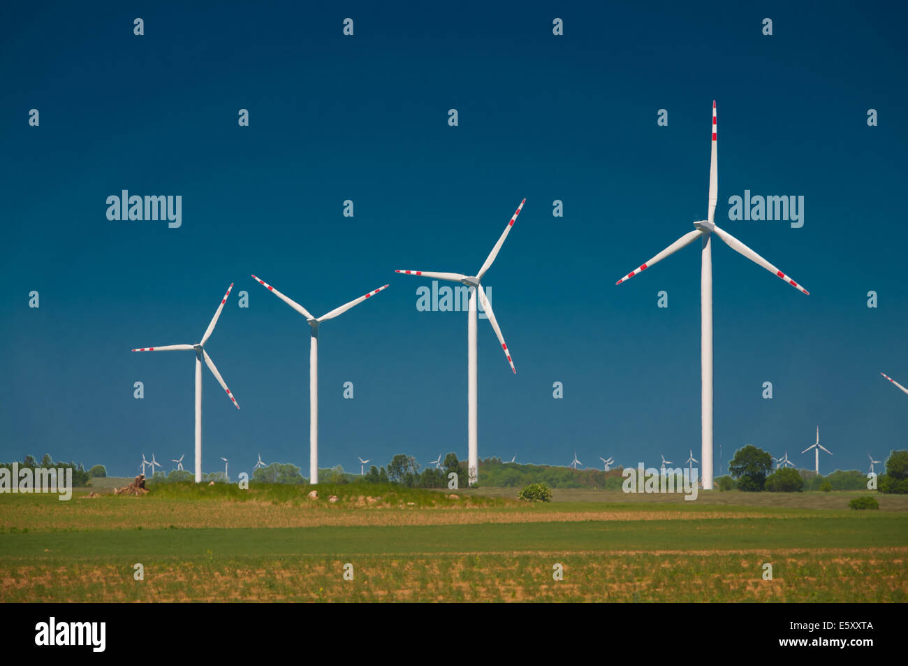 Rotating wind turbines green grass hi-res stock photography and images ...