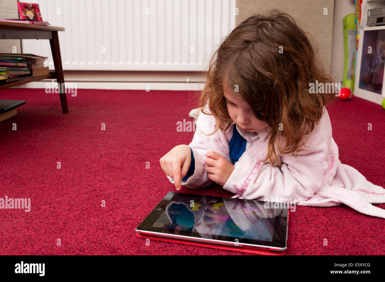 Young girl child using tablet computer Stock Photo - Alamy