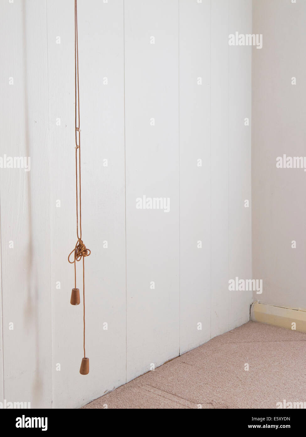 Window blind cord dangling beside wall presenting a dangerous hazard ...