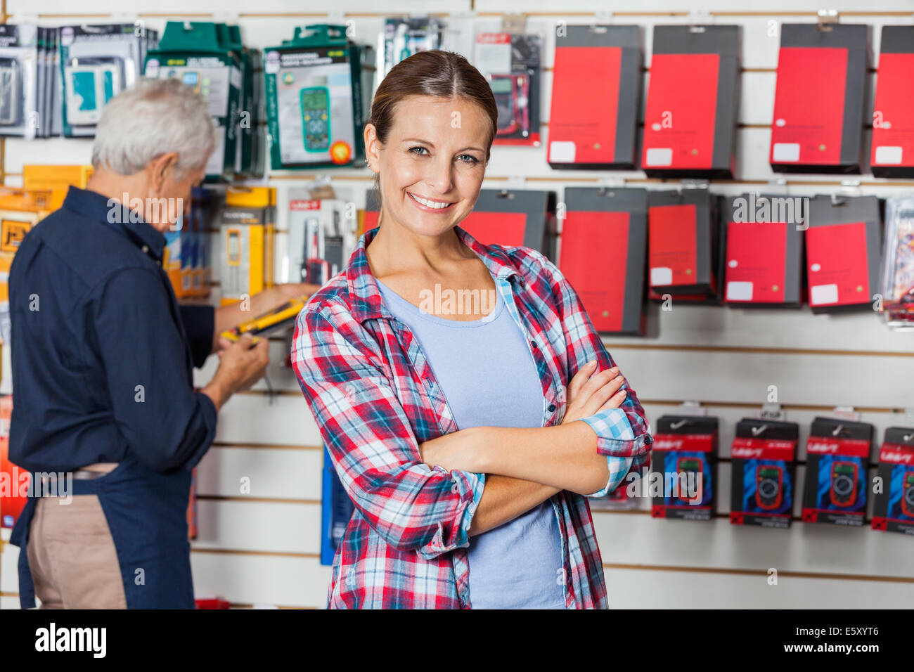 Confident Woman With Arms Crossed In Hardware Store Stock Photo - Alamy