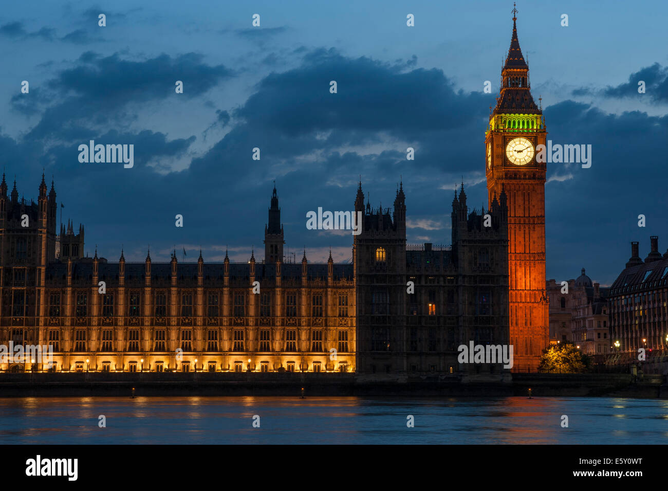 The tower of Big Ben after sunset in summer with lights reflected on ...