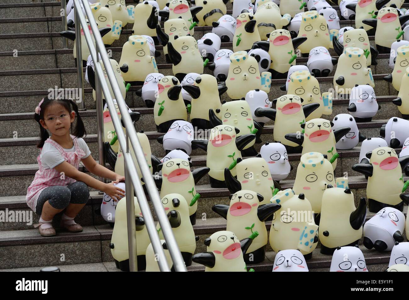Shanghai, China. 8th Aug, 2014. A child poses for photo with "Pan Da ...