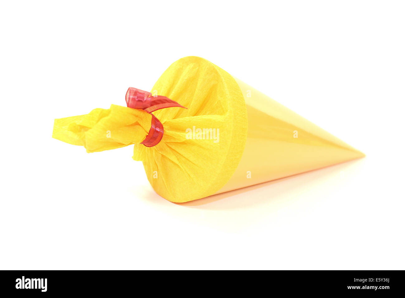 yellow school cone with red ribbon on a light background Stock Photo ...