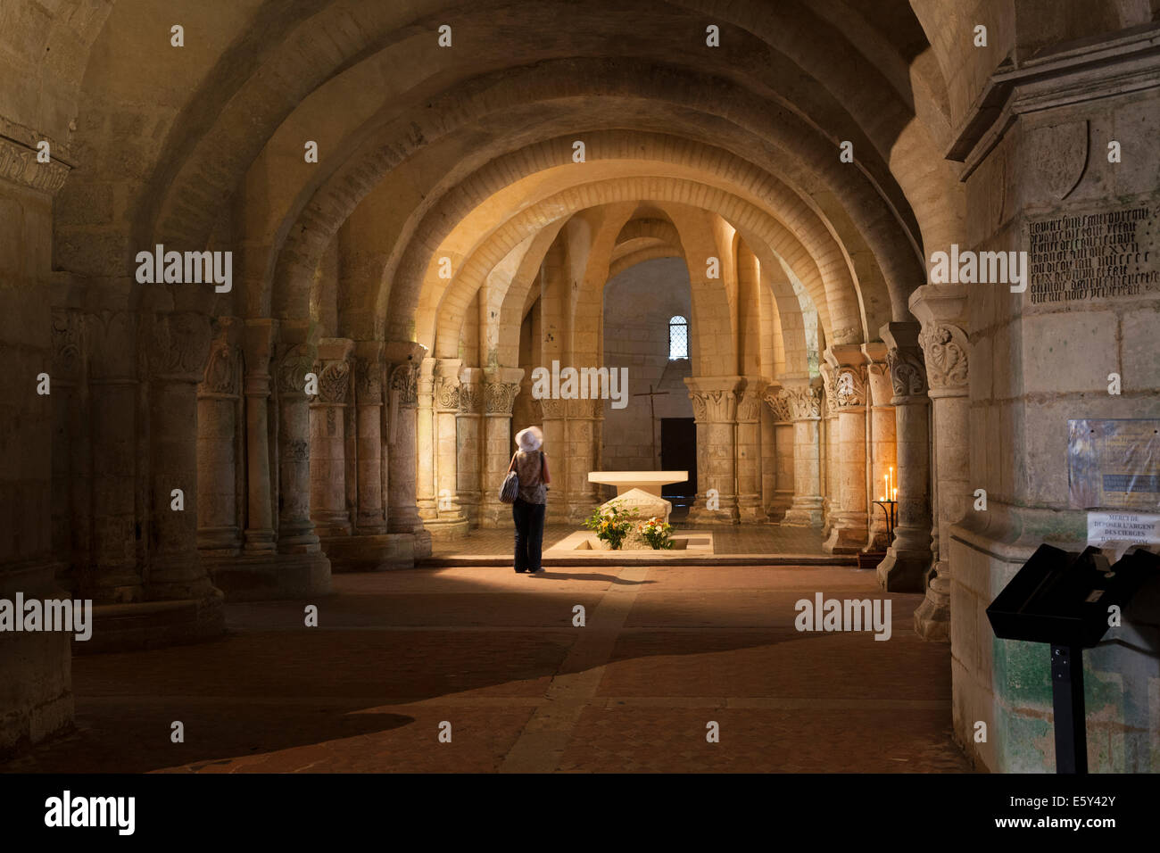 A tourist in the crypt of the Basilica of Saint Eutropius in Saintes ...