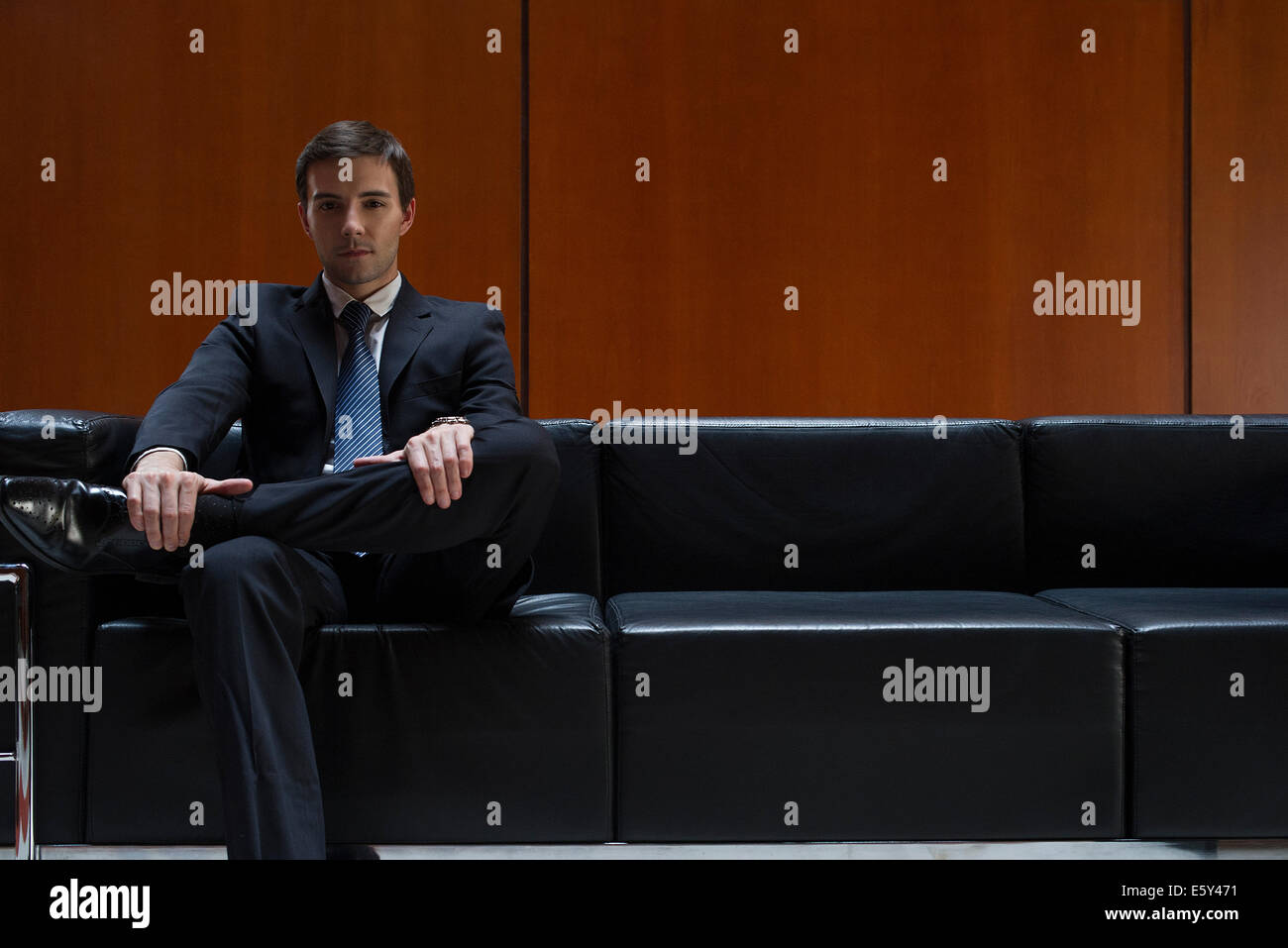 Businessman sitting in waiting room, portrait Stock Photo - Alamy