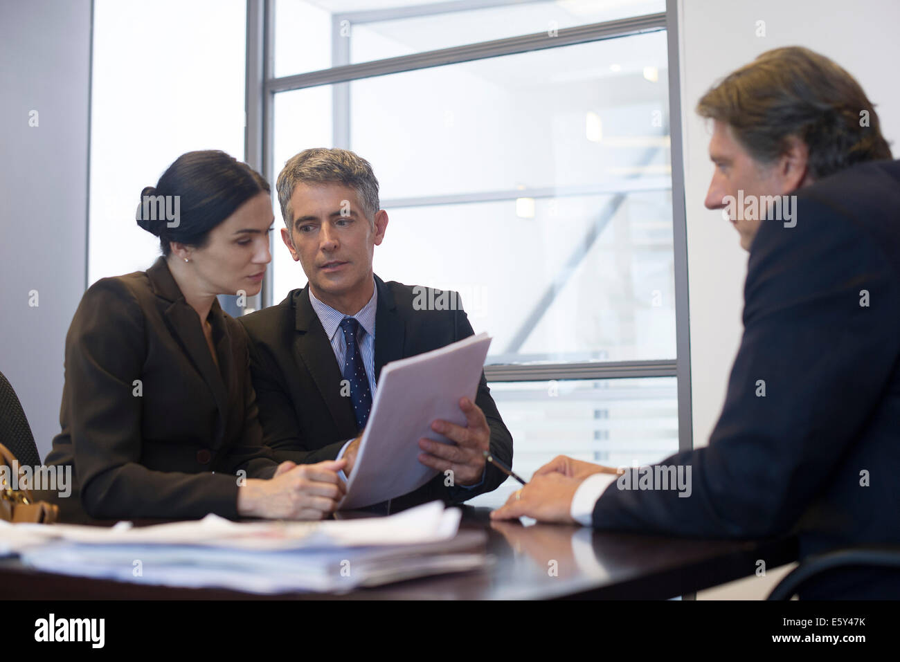 Business meeting, business associates reviewing contract Stock Photo ...