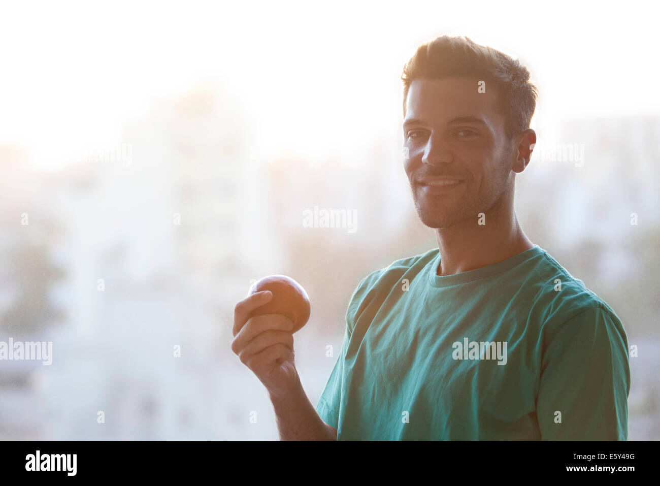 Man holding apple, portrait Stock Photo - Alamy