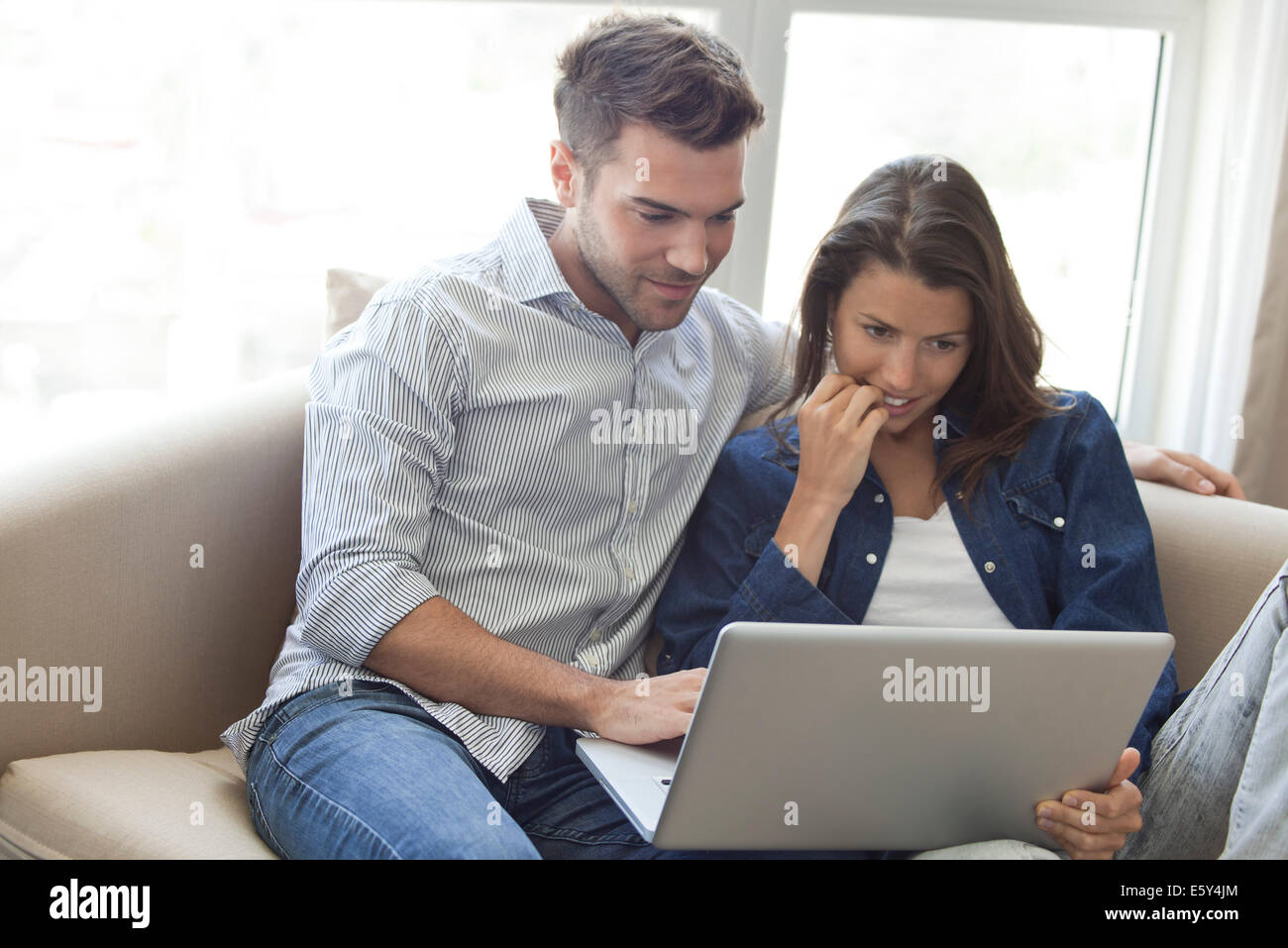 Couple using laptop computer together at home Stock Photo - Alamy