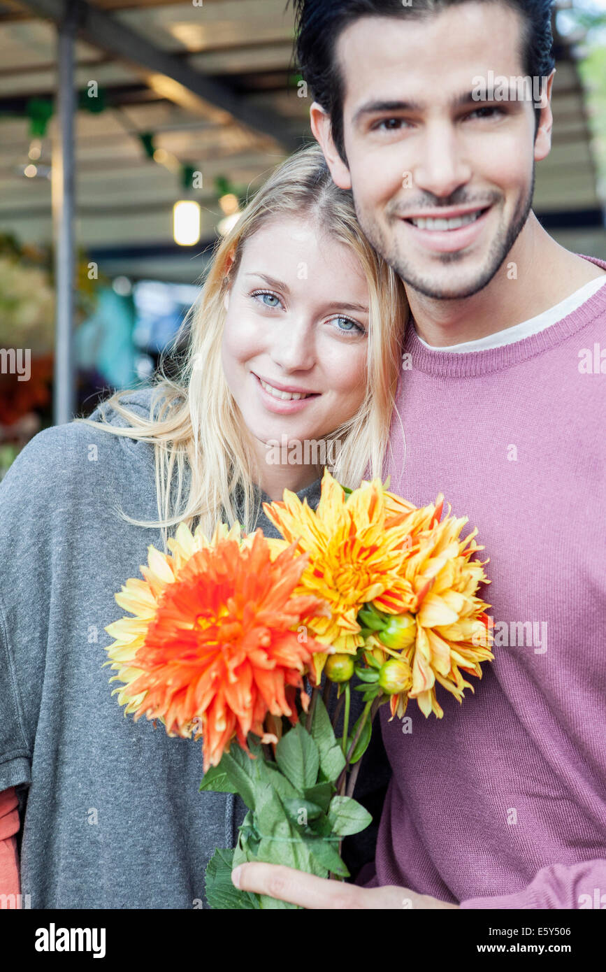 Couple with flower bouquet, portrait Stock Photo - Alamy