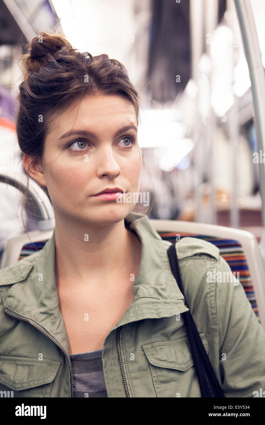 Young woman riding subway train Stock Photo - Alamy